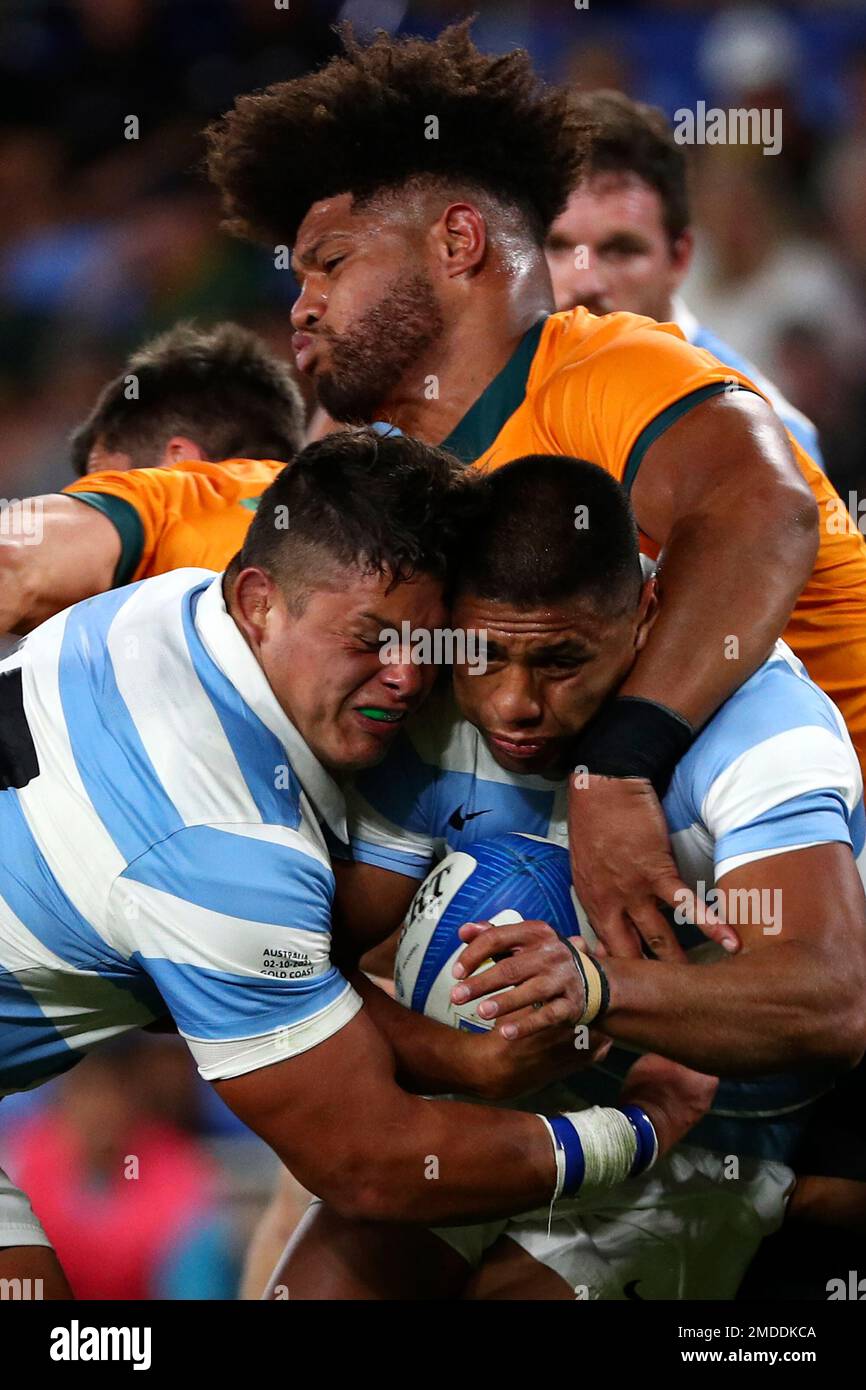 Australia's Rob Valentini, center, wraps up Argentina's Gonzalo ...