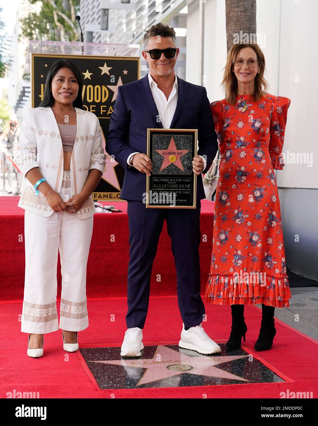 Spanish musician Alejandro Sanz, center, poses atop his new star on the ...