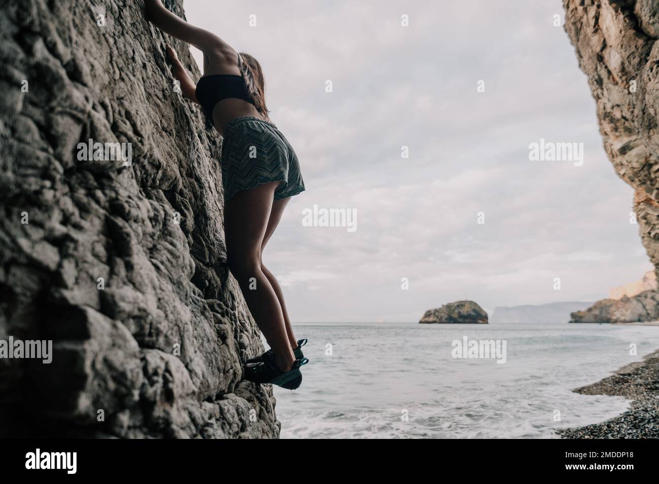 Sports Woman Climbing The Rock. Young woman With slim fit body climbing ...
