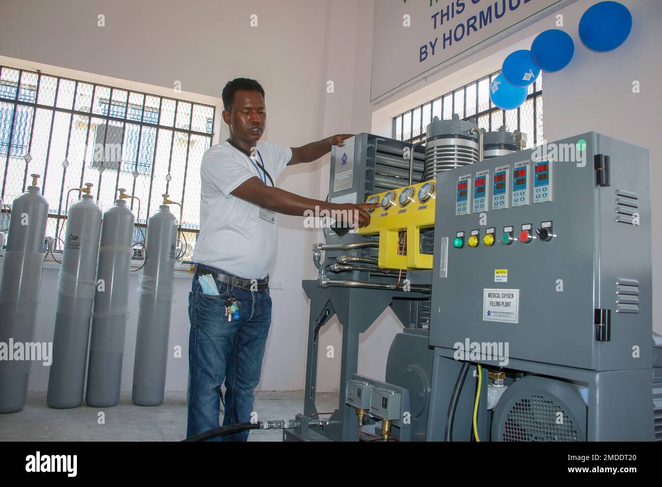 A worker operates the machinery during an event to unveil a new oxygen ...