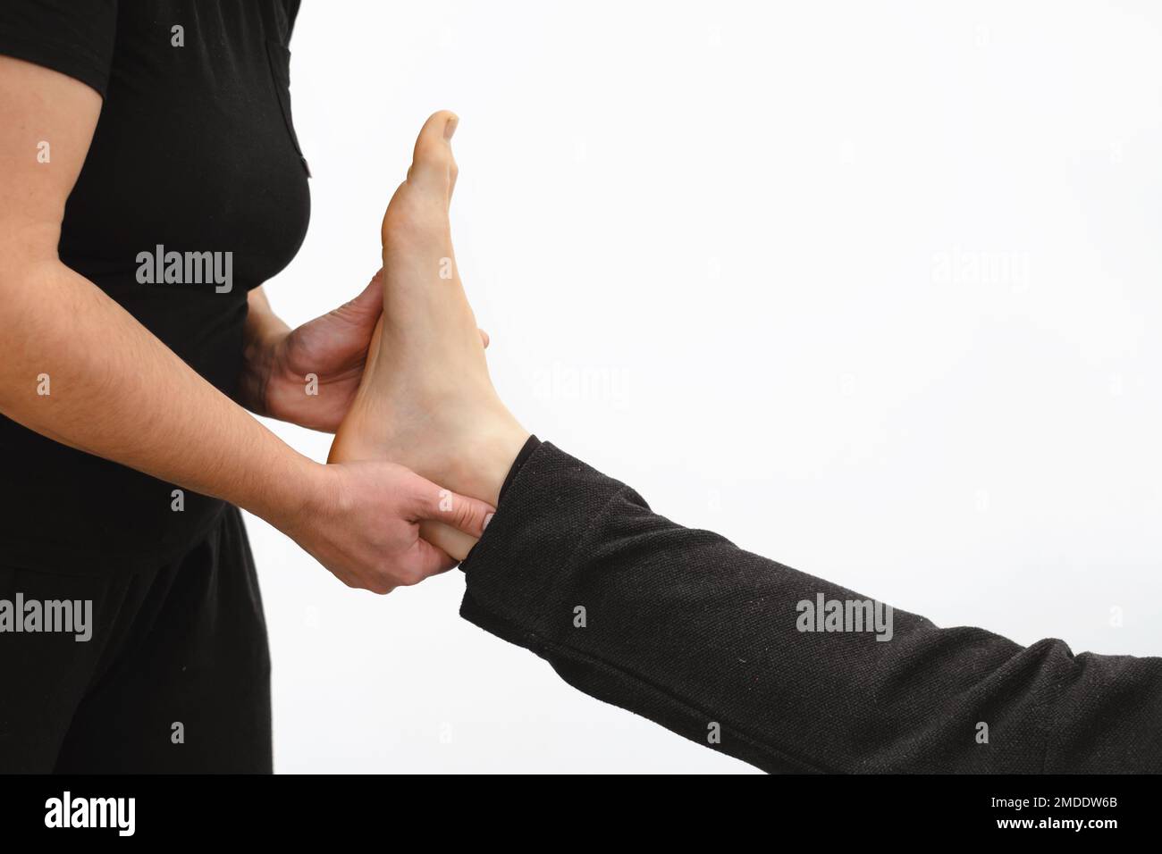 therapist holding leg and foot of patient. treatment is health center ...
