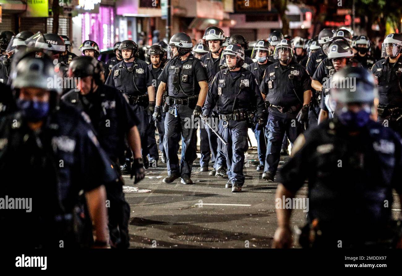 FILE - In this May 30, 2020, file photo, police in riot gear gather ...