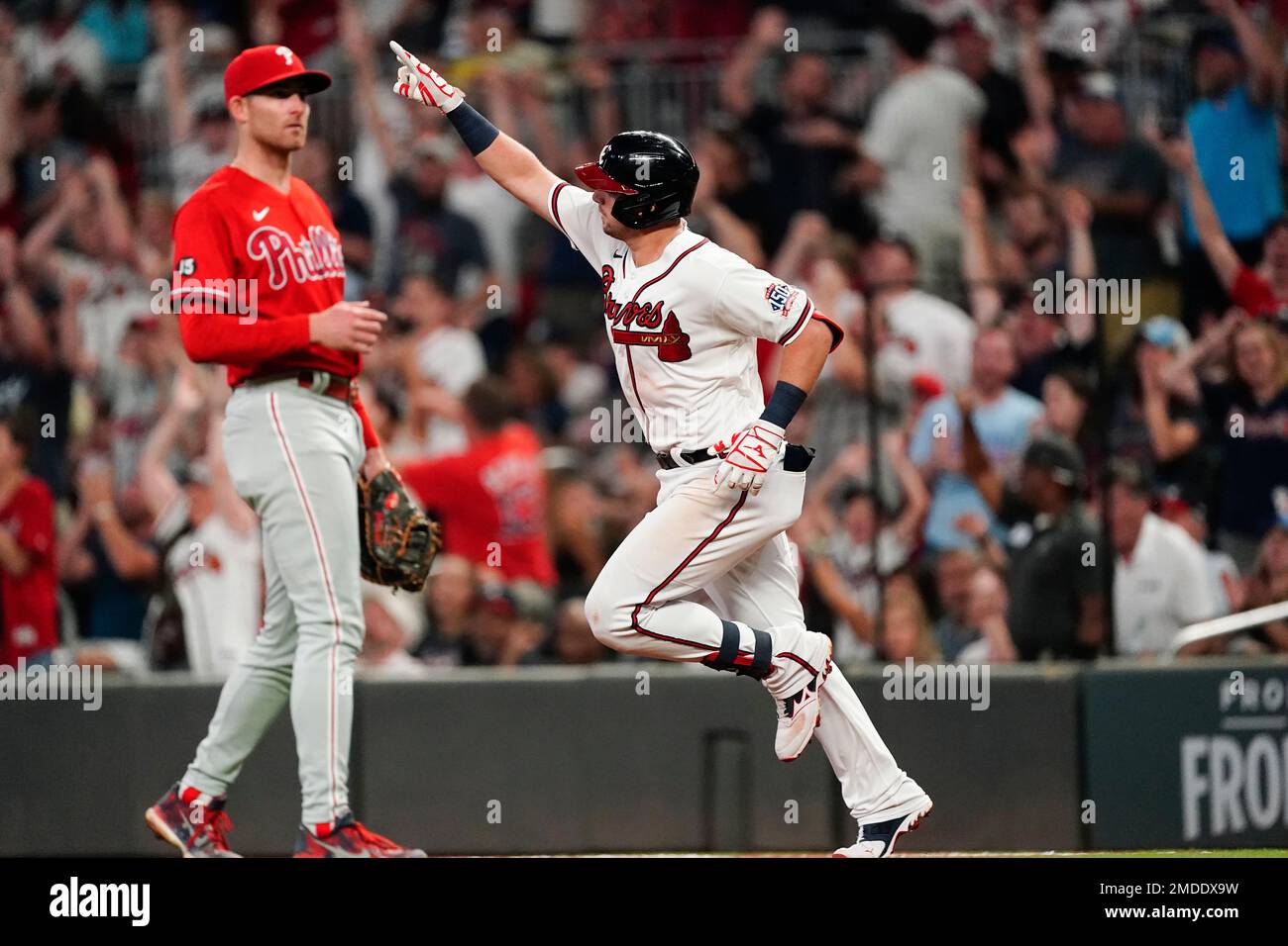 Atlanta Braves' Austin Riley, right, gestures as he runs past ...