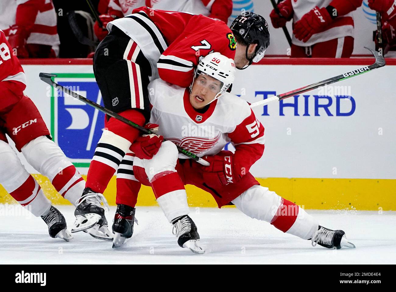 Detroit Red Wings right wing Dominik Shine, right, checks Chicago ...
