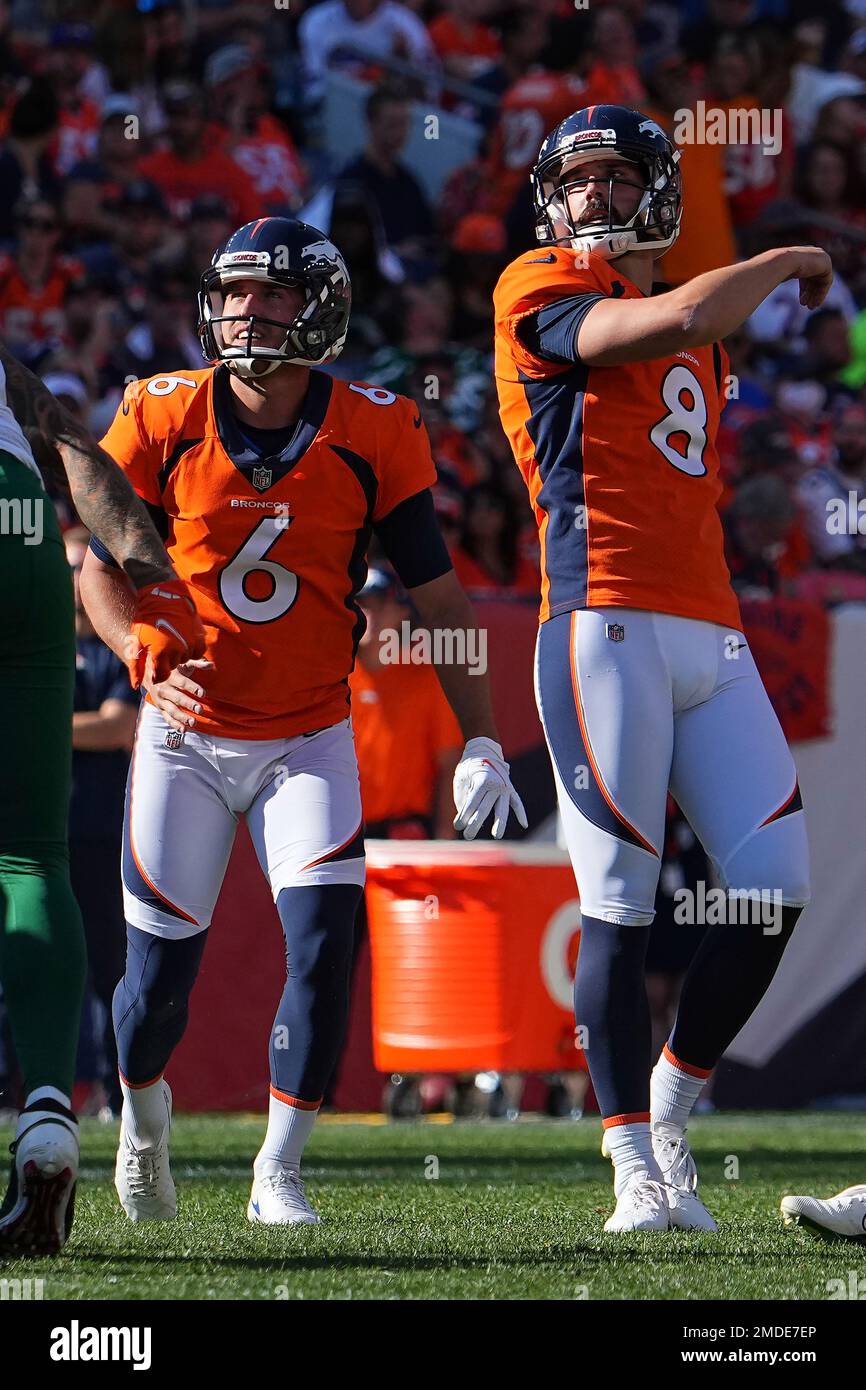 Sam Martin and Brandon Mcmanus of the Denver Broncos react to a kick ...
