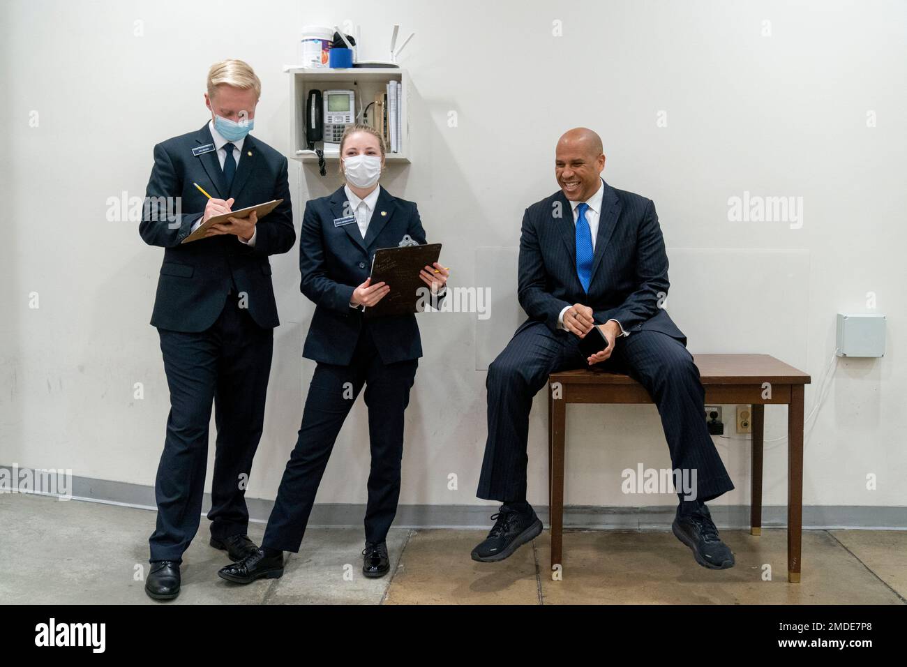 Sen. Cory Booker, D-N.J., shares a laugh with Senate pages as he waits ...