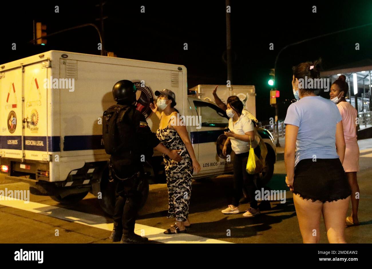 Relatives of inmates wait for news as a coroners truck arrives to the ...