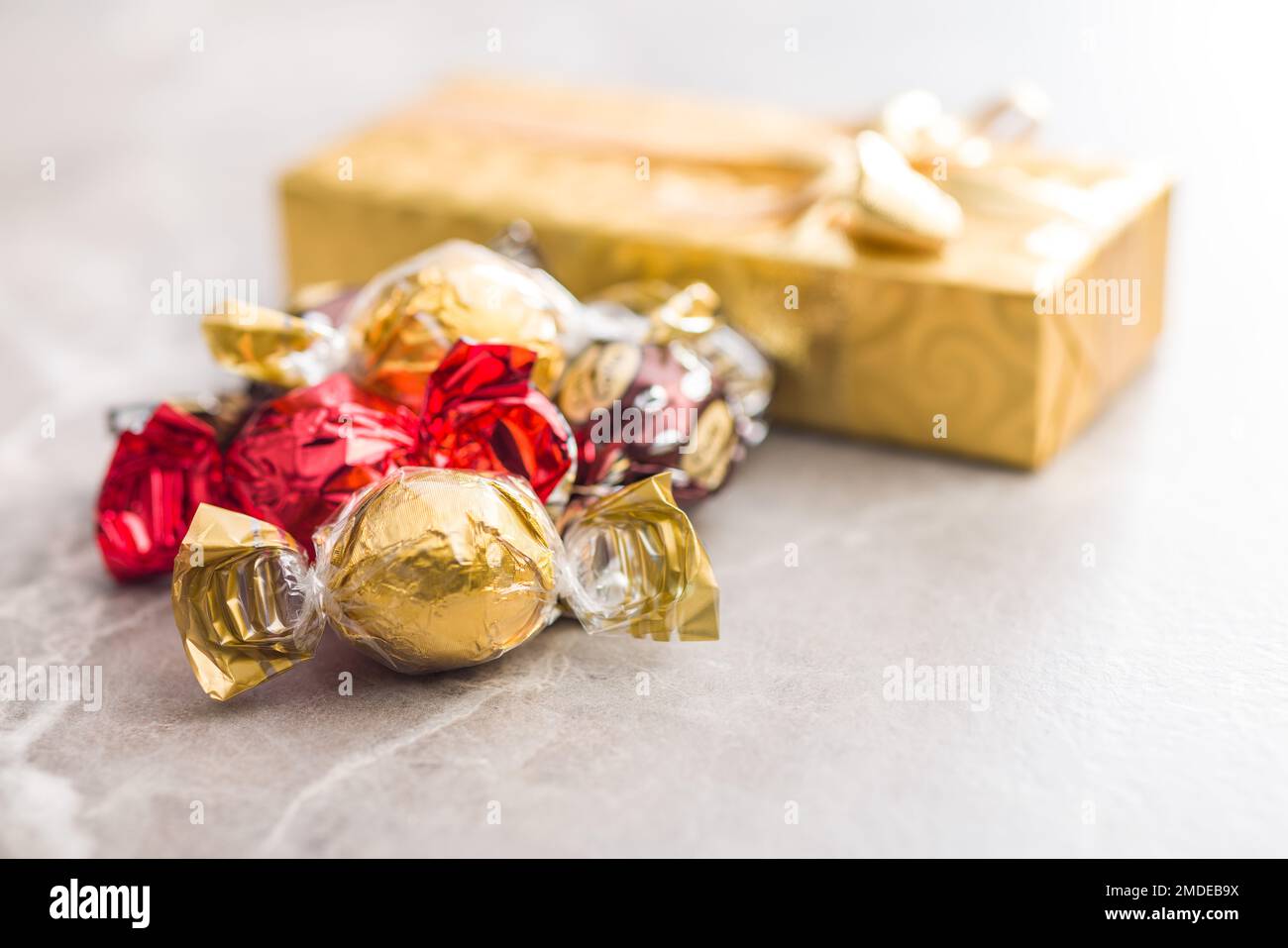 Sweet candy wrapped in foil on the kitchen table Stock Photo - Alamy