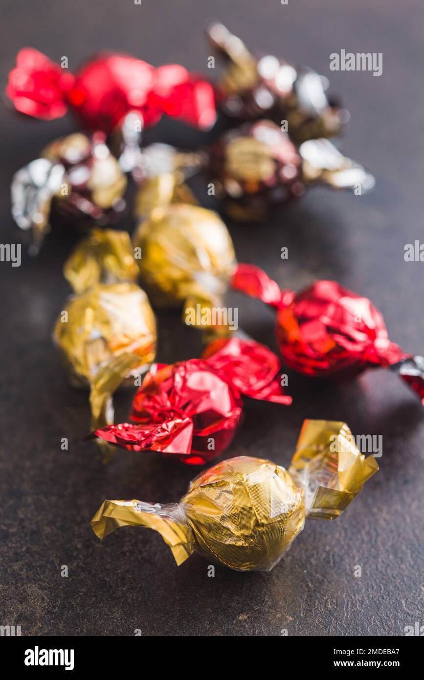 Sweet candy wrapped in foil on the kitchen table Stock Photo - Alamy