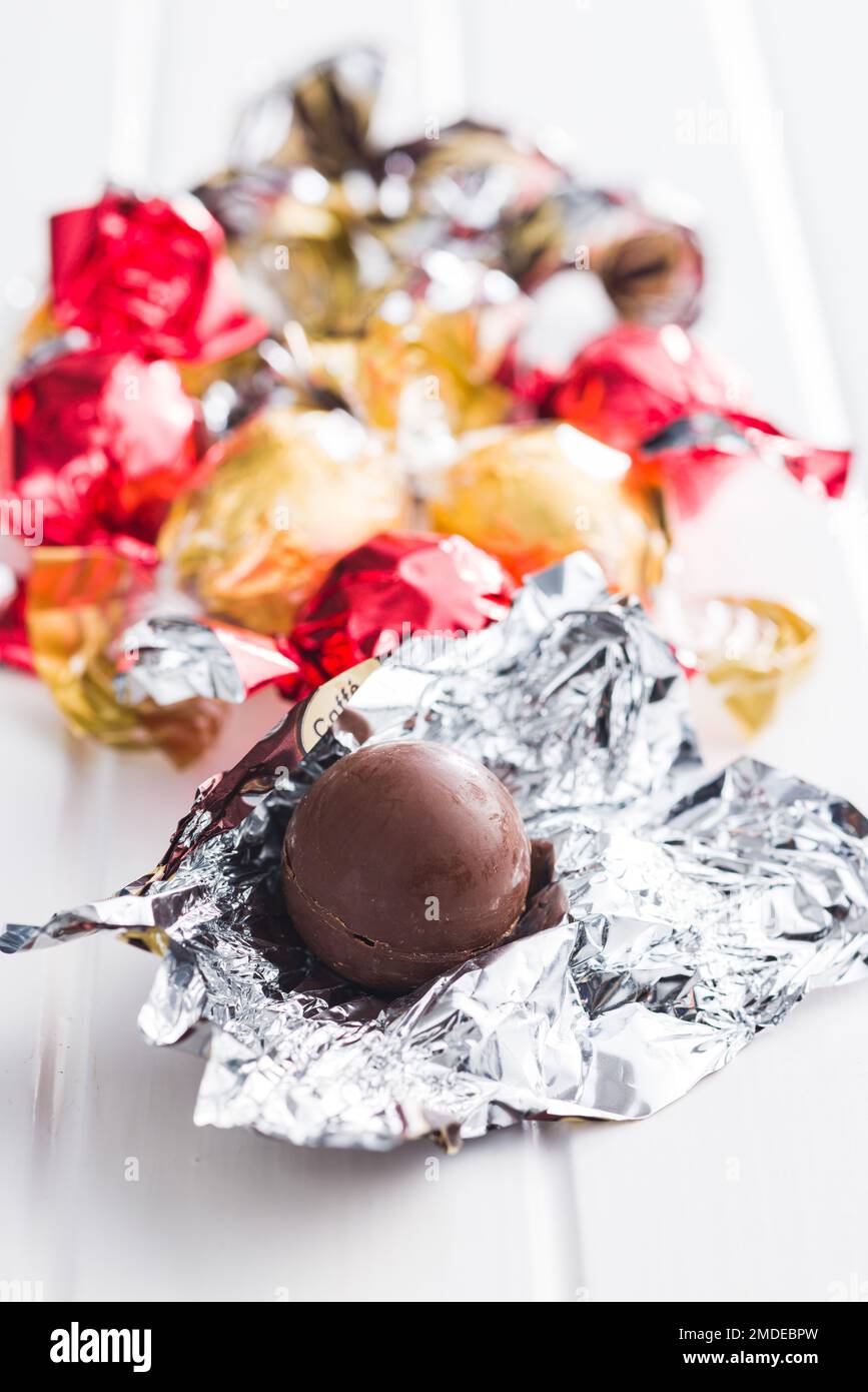 Sweet chocolate candy wrapped in foil on the kitchen table Stock Photo ...