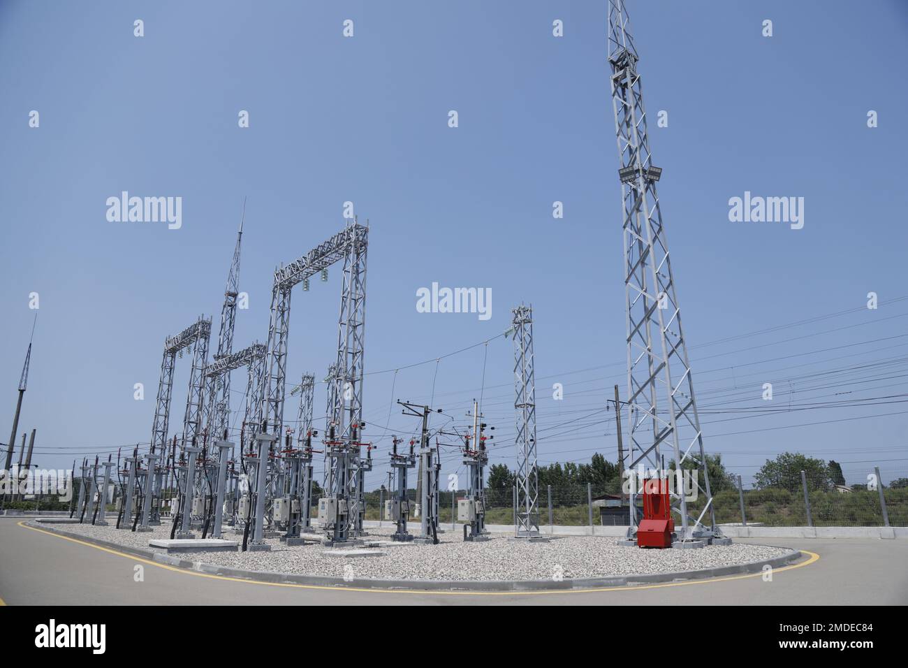 An aerial view of electrical substation surrounded by metal towers ...