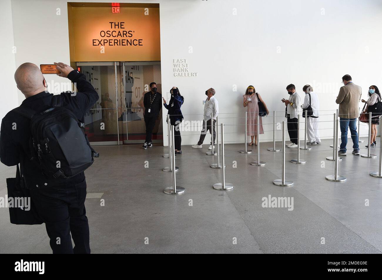 FILE - People wait up for The Oscars Experience exhibit at the Academy ...