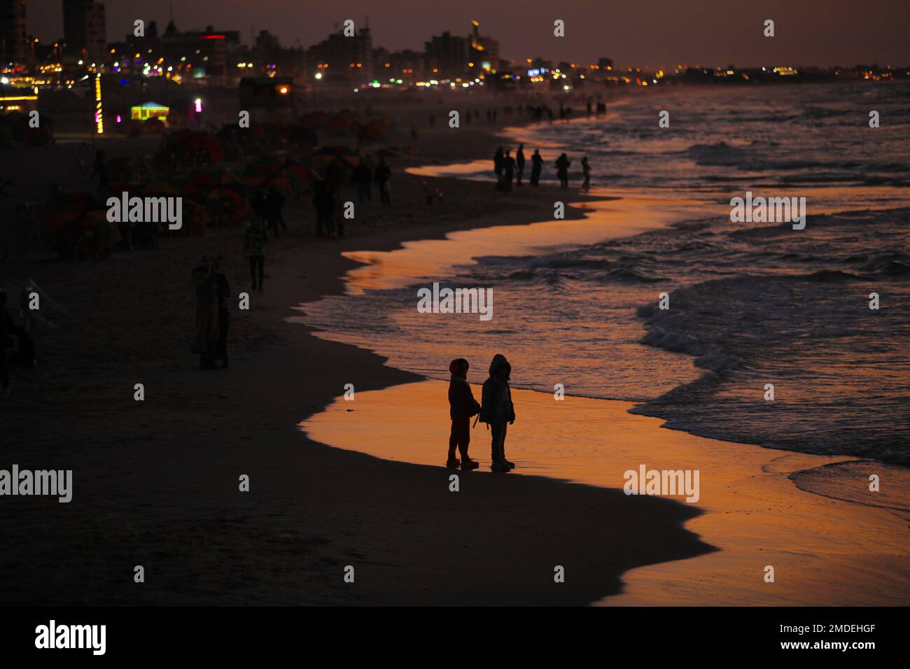 Palestinians enjoying the sunset on the beach of Gaza City. Palestine ...