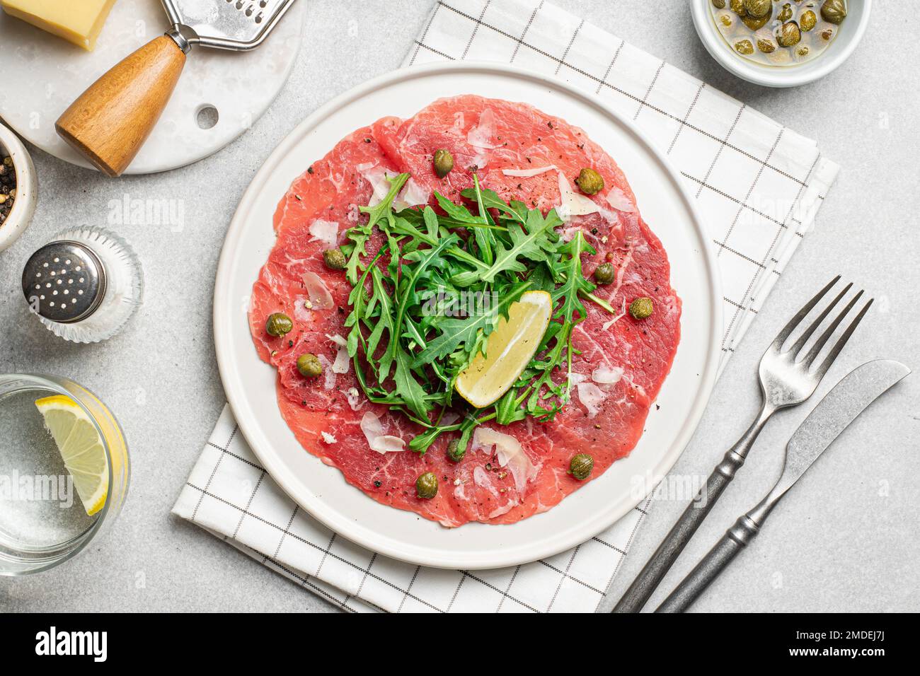 Beef carpaccio with capers, arugula and parmesan Stock Photo - Alamy