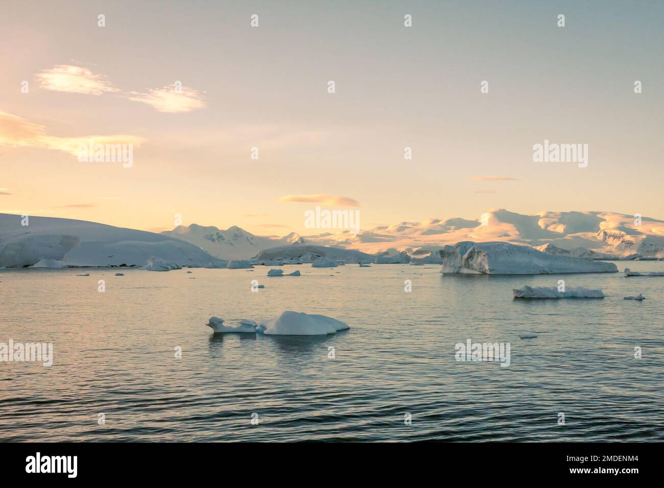 it is late in the evening when the sun sets over the ice covered ...