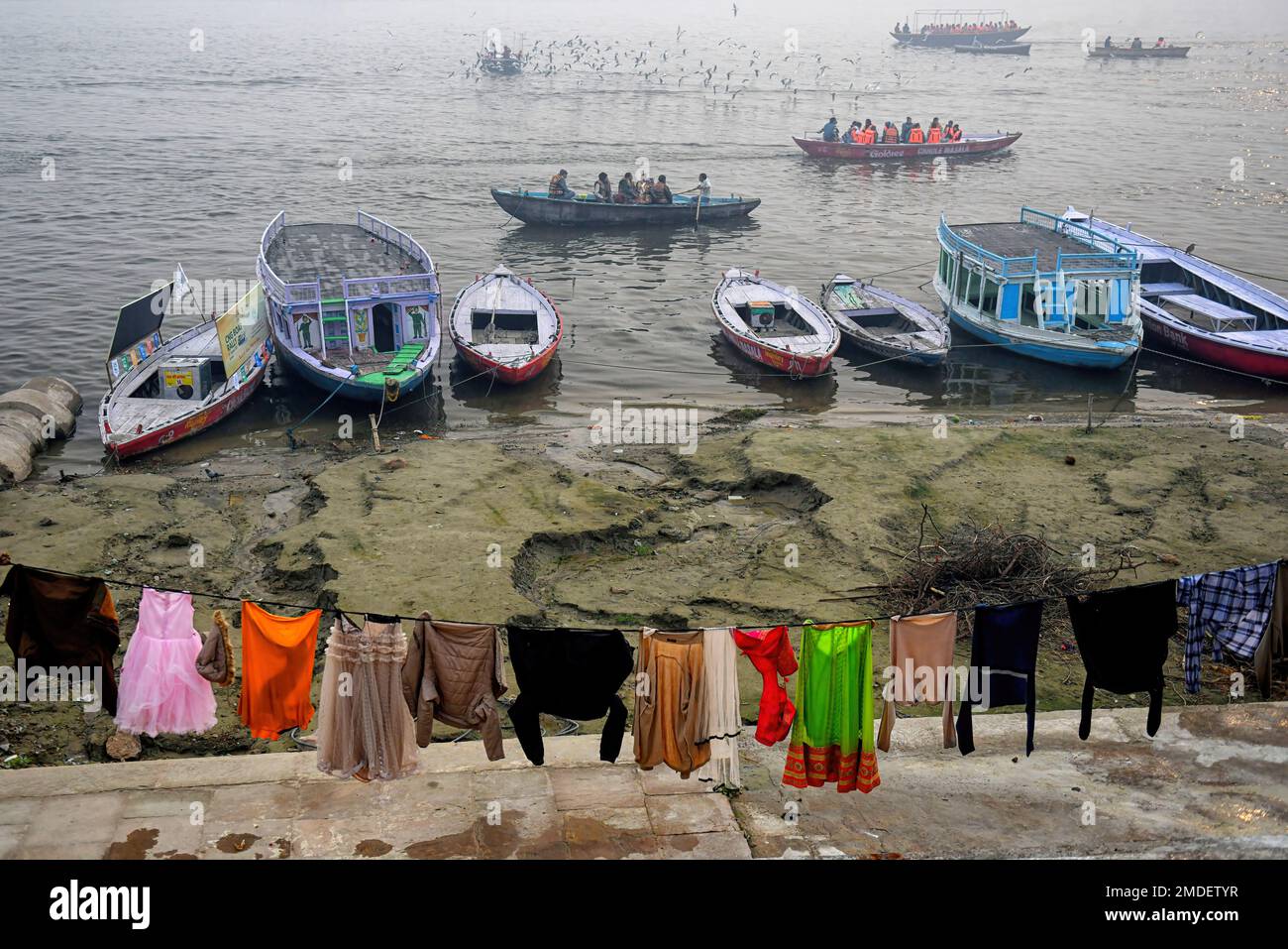 Varanasi, India. 22nd Jan, 2023. Tourists sit on the boats at the ...