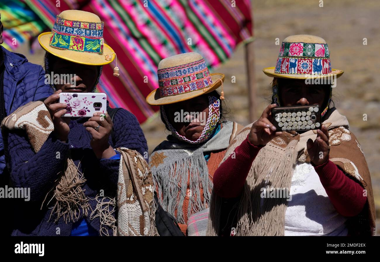Aymara Indigenous women take photos with their mobile phones of the ...