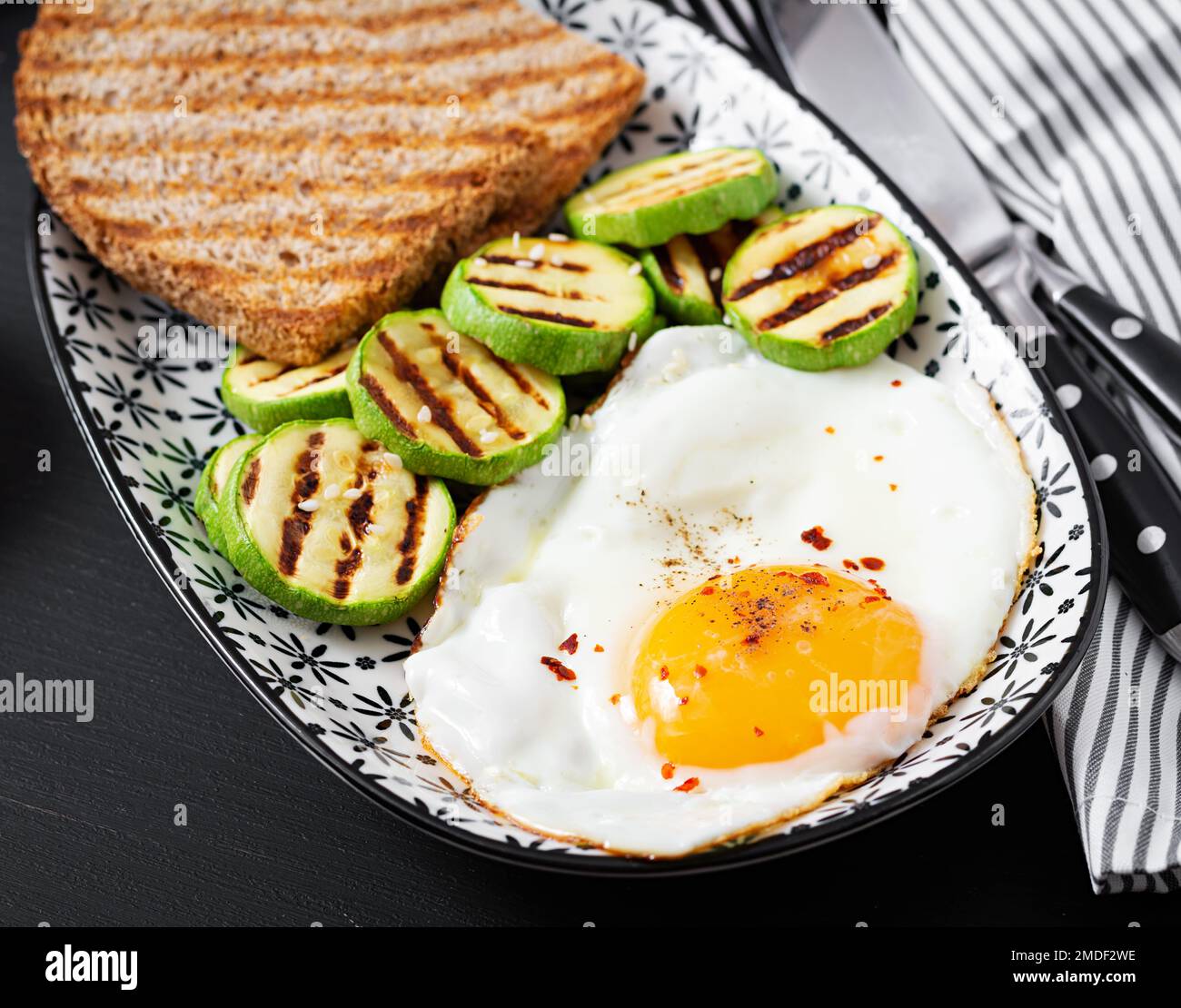 Breakfast. Toast with avocado guacamole, grilled zucchini and fried egg ...