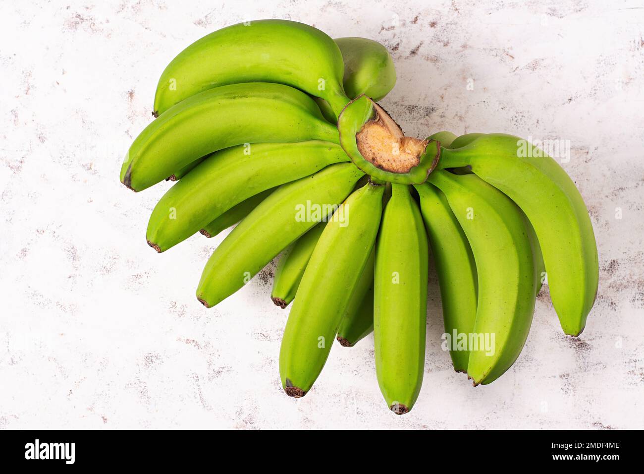 A bunch of fresh green bananas on a light background Stock Photo - Alamy