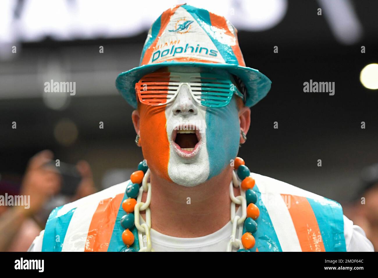 A Miami Dolphins fan cheers during the first half of an NFL football ...