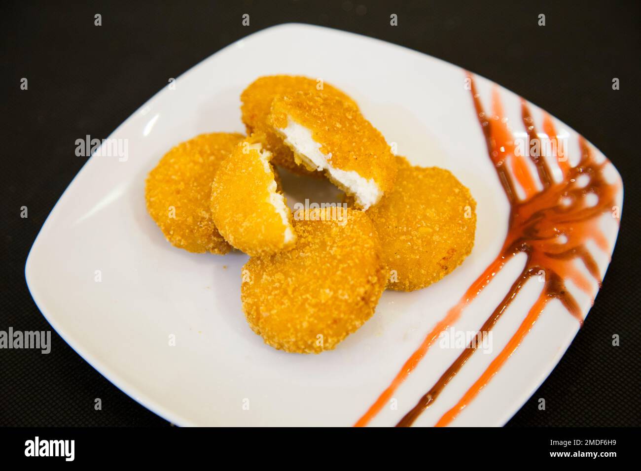 Deep fried brie cheese with berries jam Stock Photo - Alamy