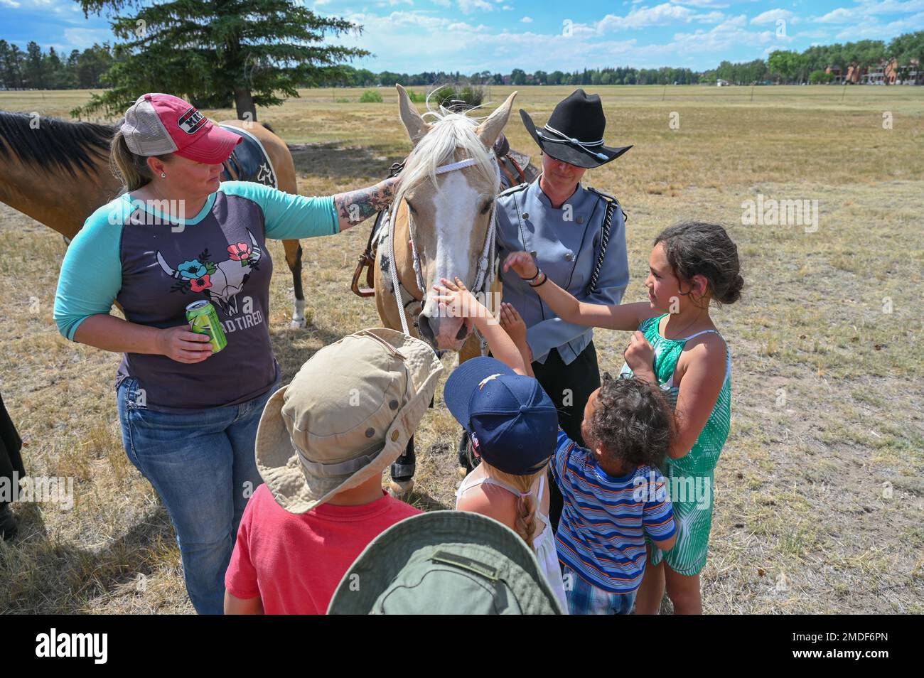 Spectators ask questions and pet the horse after the Trotters Cavalry ...