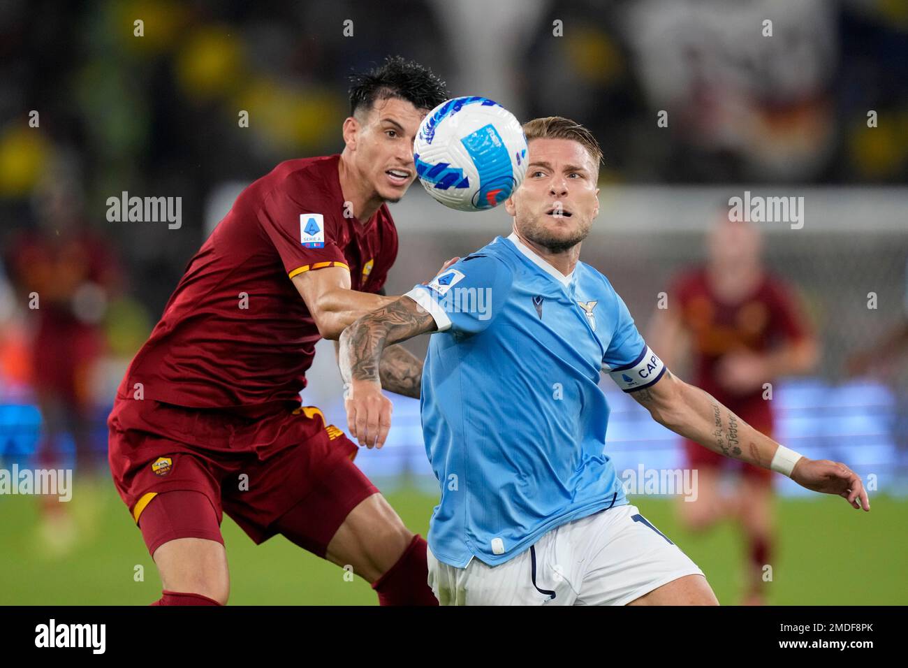 Lazio's Ciro Immobile shields the ball from Roma's Roger Ibanez, left ...