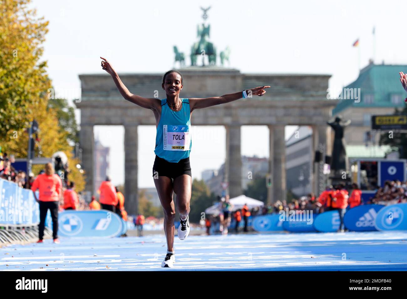 Ethiopia's Helen Tola reacts as she crosses the finish line in the ...