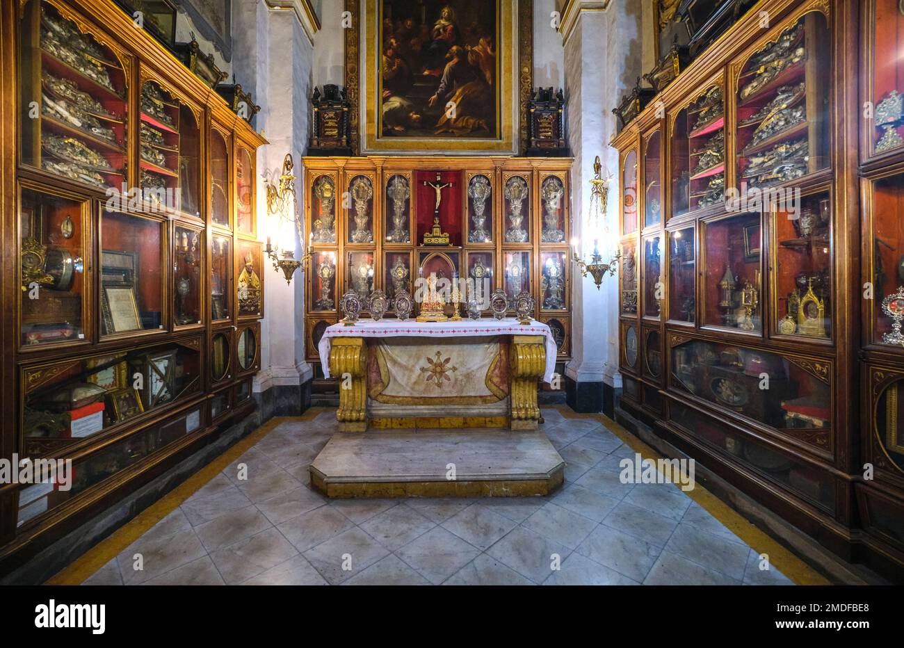 A room with cases diplaying many church relics, icons, historical ...