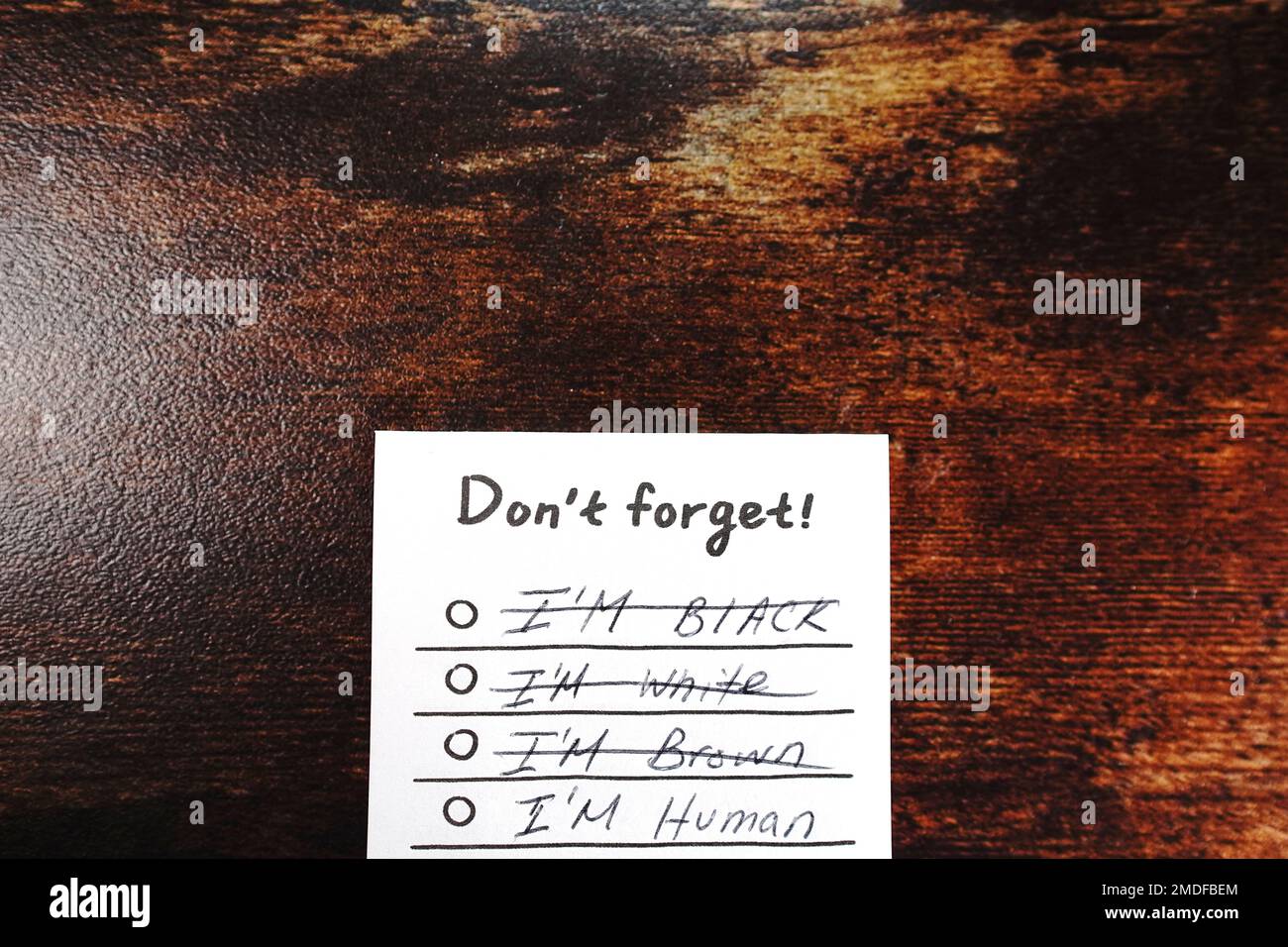 Message I'm human don't forget on wood desk i'm not black I'm not white ...