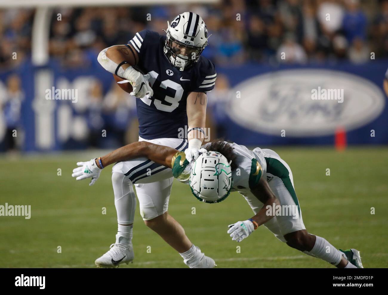 BYU fullback Masen Wake (13) stiff arms a tackle by South Florida ...