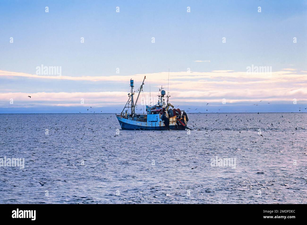 Fishing boat trawling at sea Stock Photo - Alamy