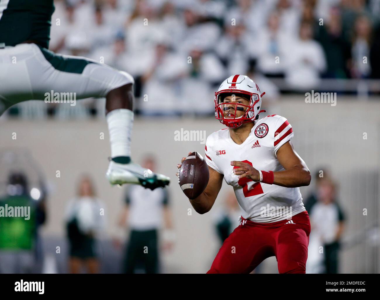 Nebraska quarterback Adrian Martinez, right, looks to throw as Michigan ...