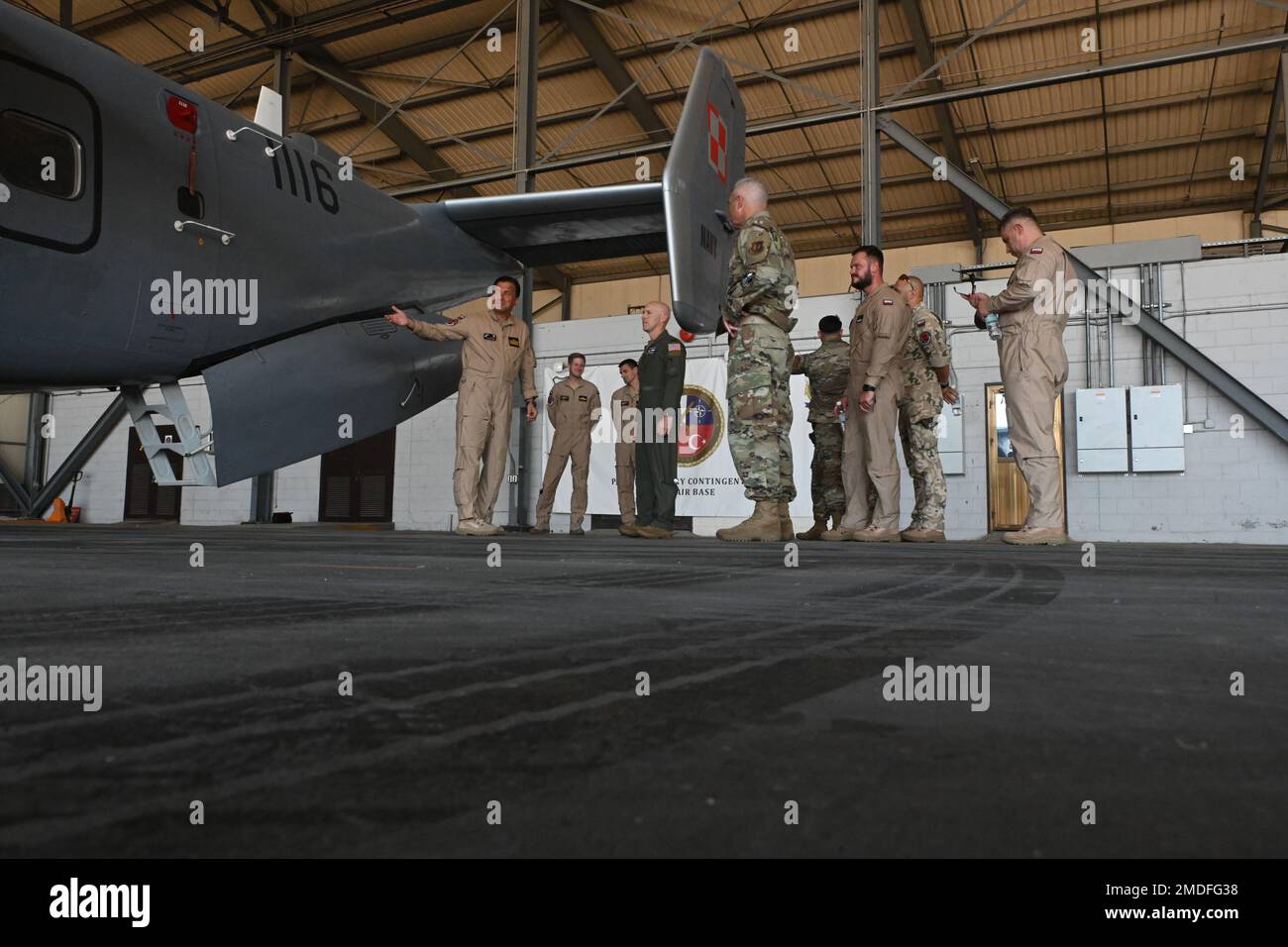Polish Military Contingent aircrew members show the 39th Air Base Wing command team their M28 ...