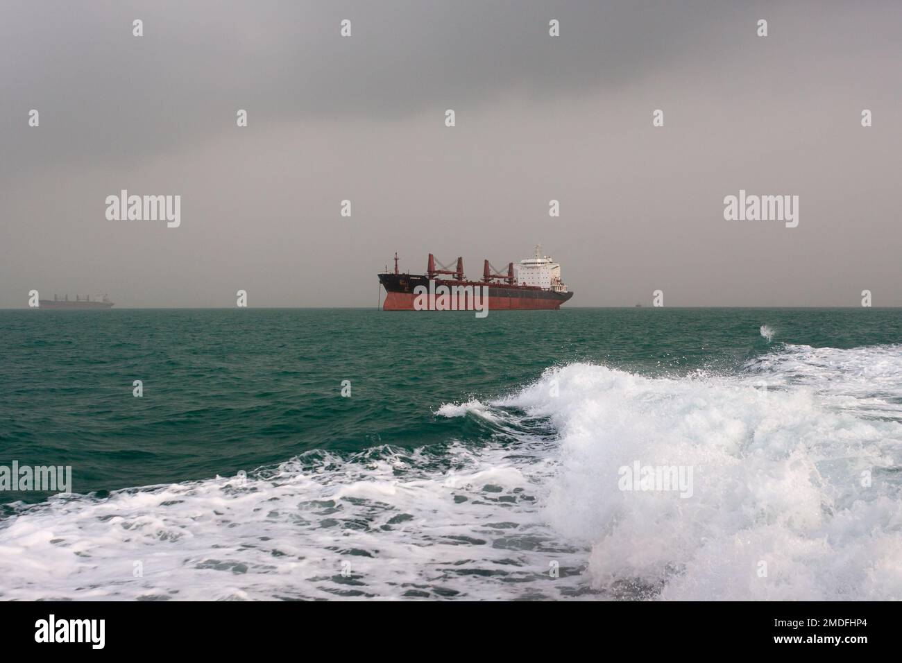 Cargo ship in Persian Gulf. Big cargo ship in open waters with white ...