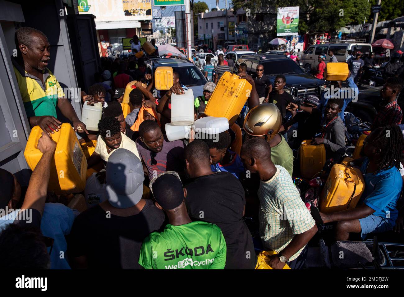 People push and shove as they try to get their tanks filled with ...