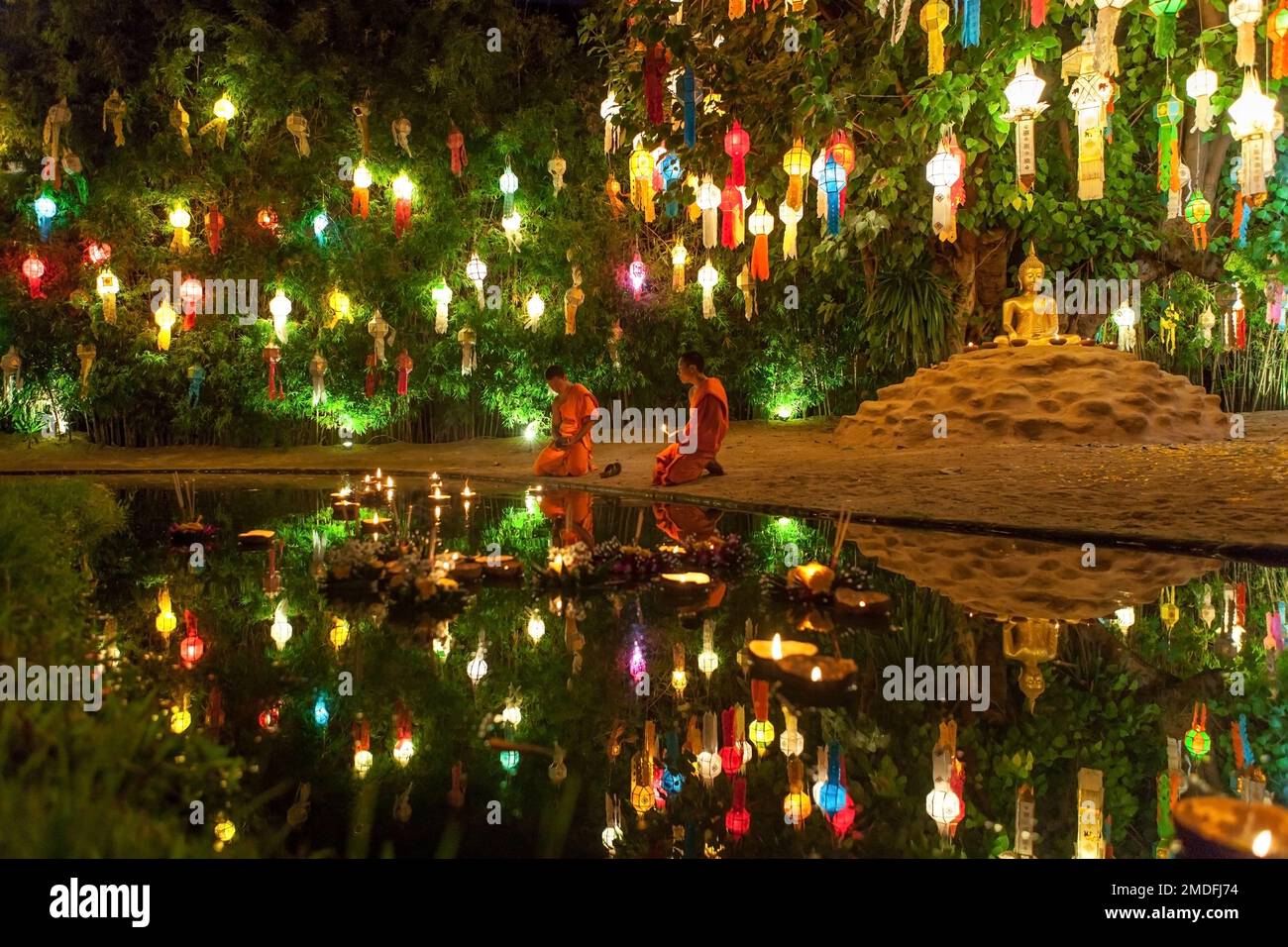 Annual Loy Krathong ceremony. Buddhist monks light and release candles ...