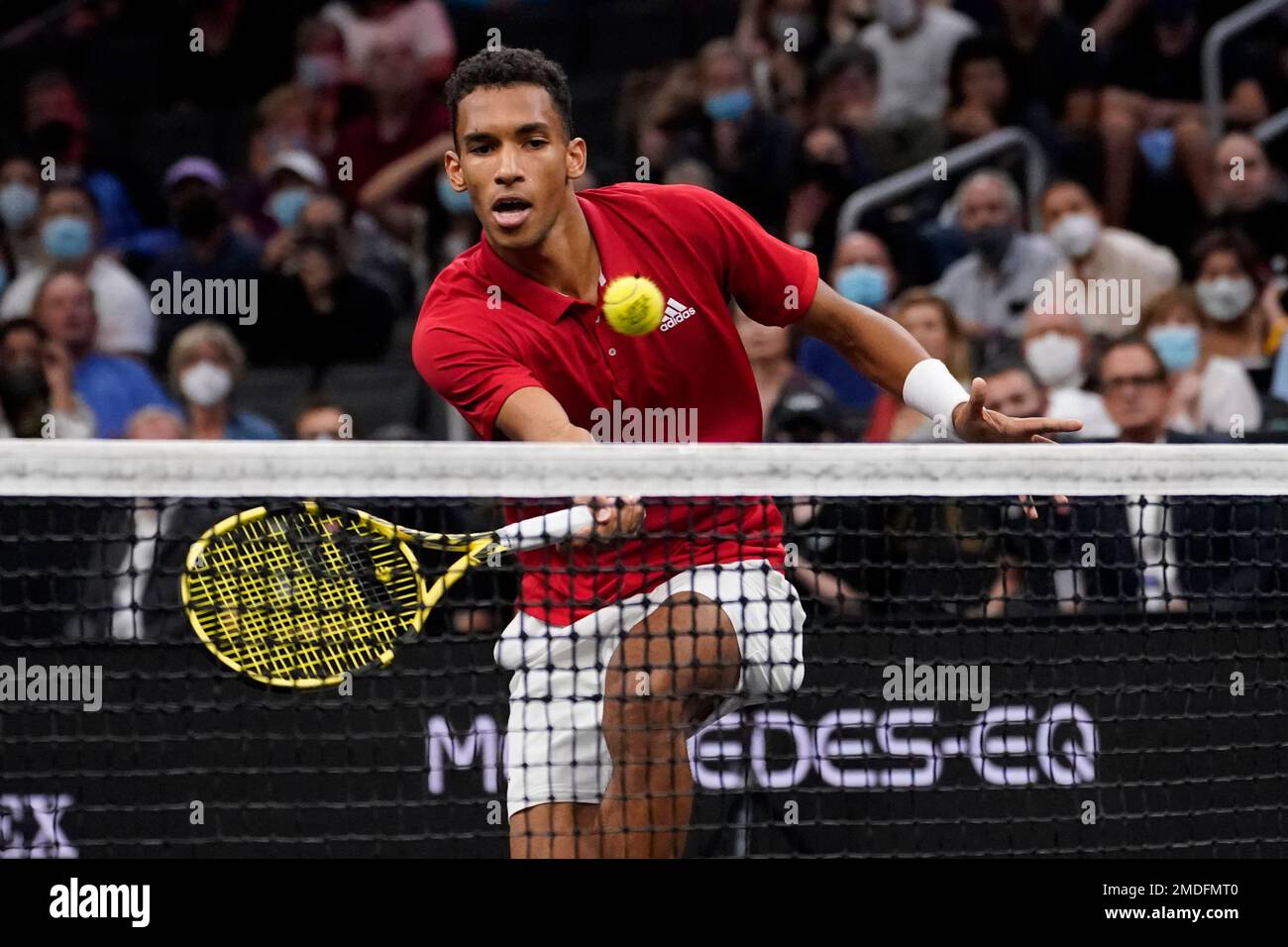 Team World's Felix Auger-Aliassime, of Canada, returns the ball to Team Europe's Matteo ...