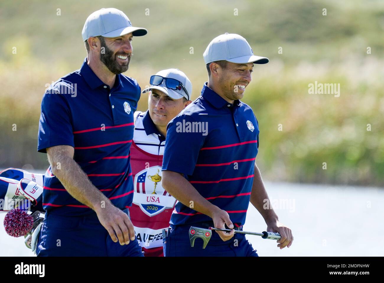 Team USA's Dustin Johnson and Team USA's Xander Schauffele smile as ...