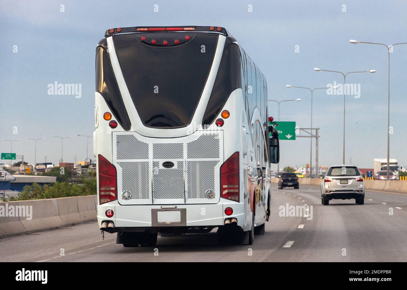 A tourist bus rides on the highway Stock Photo - Alamy