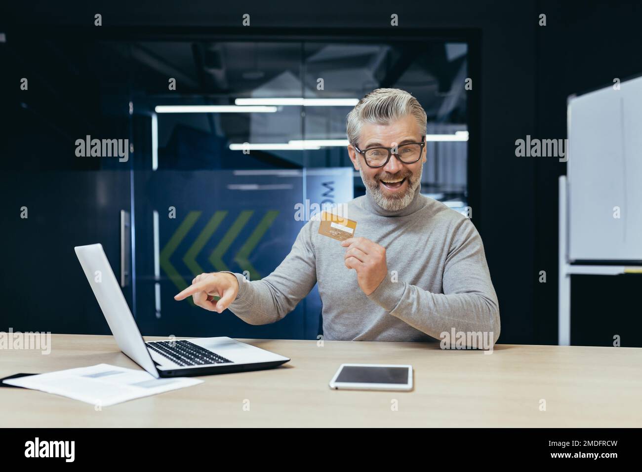 Successful gray haired businessman rejoices and celebrates completion ...