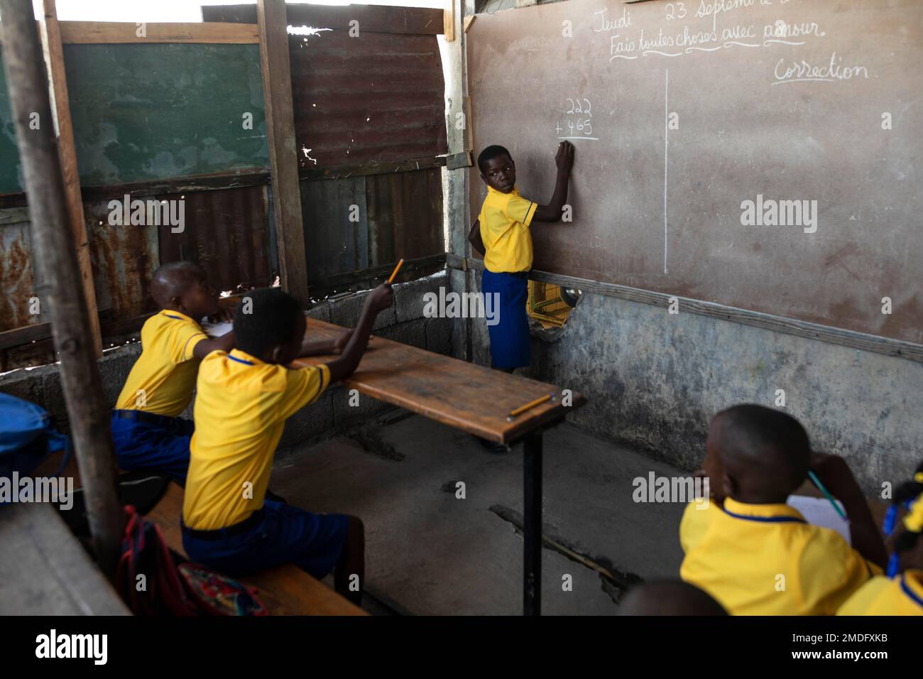 Students attend a class in the Sante Bernadette school, inside Fort ...