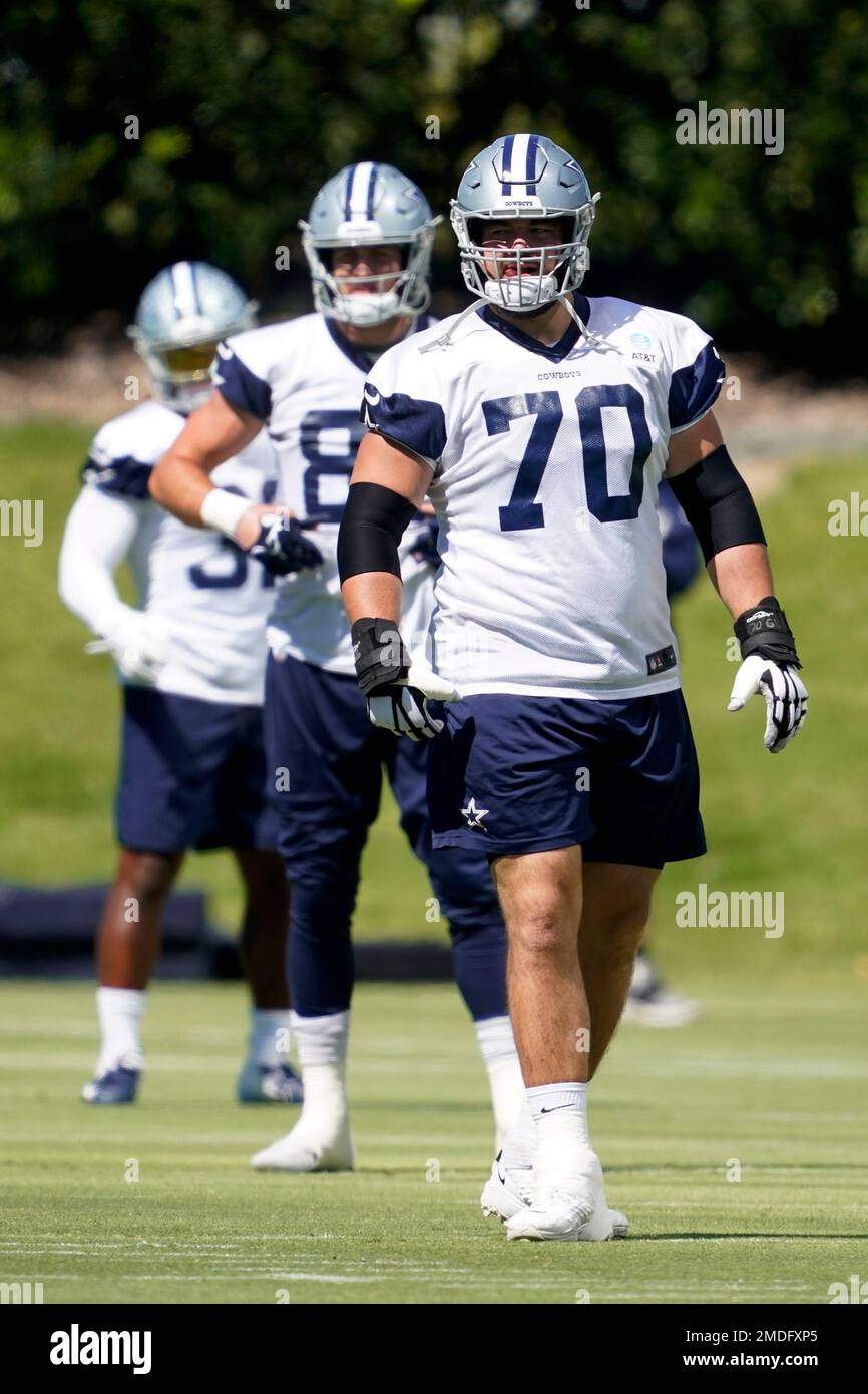 Dallas Cowboys guard Zack Martin (70) stretches with teammates before ...