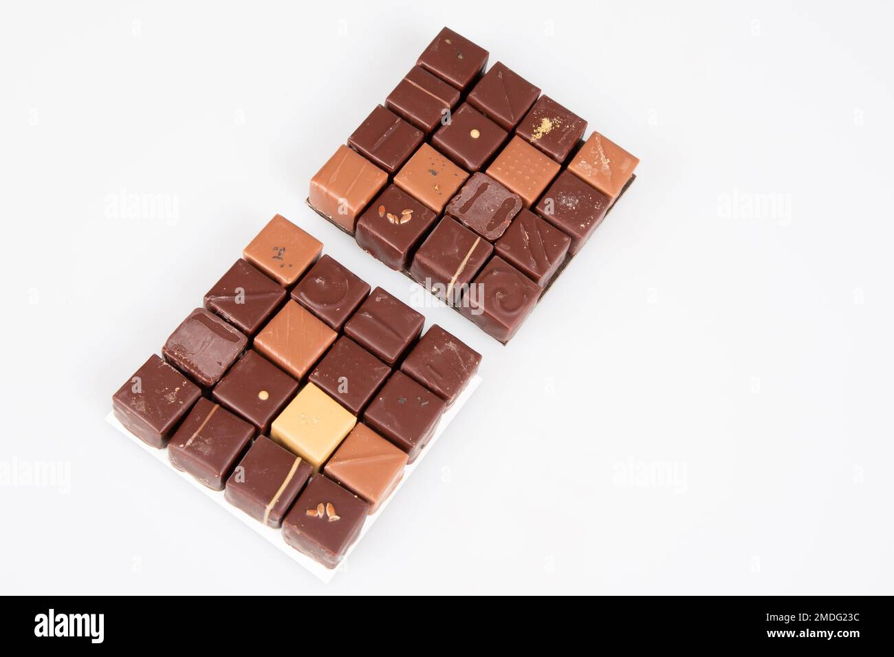 some square chocolate pralines in top view in white background Stock ...