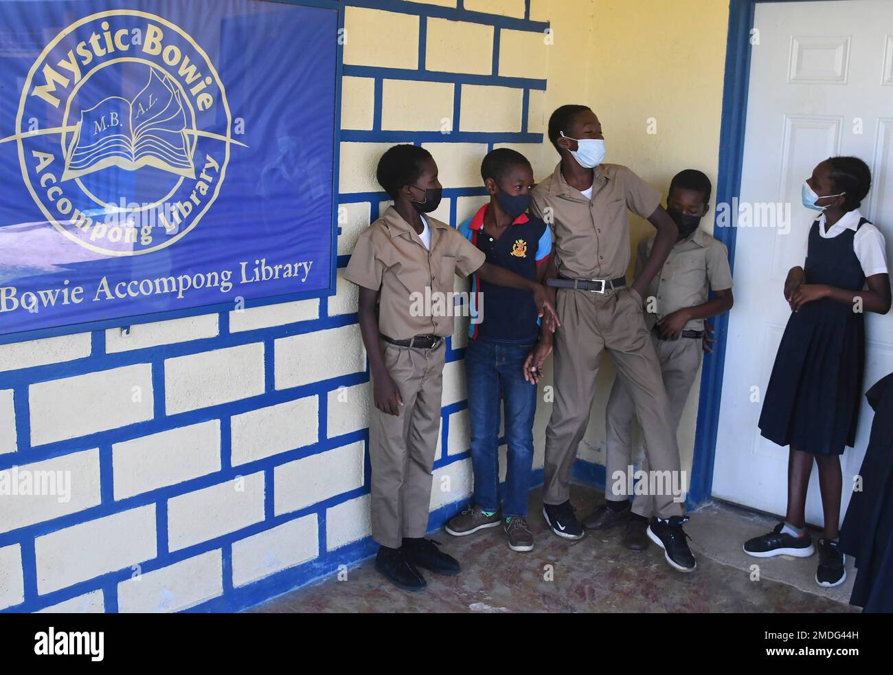 Primary School students gather outside the school library taking a ...