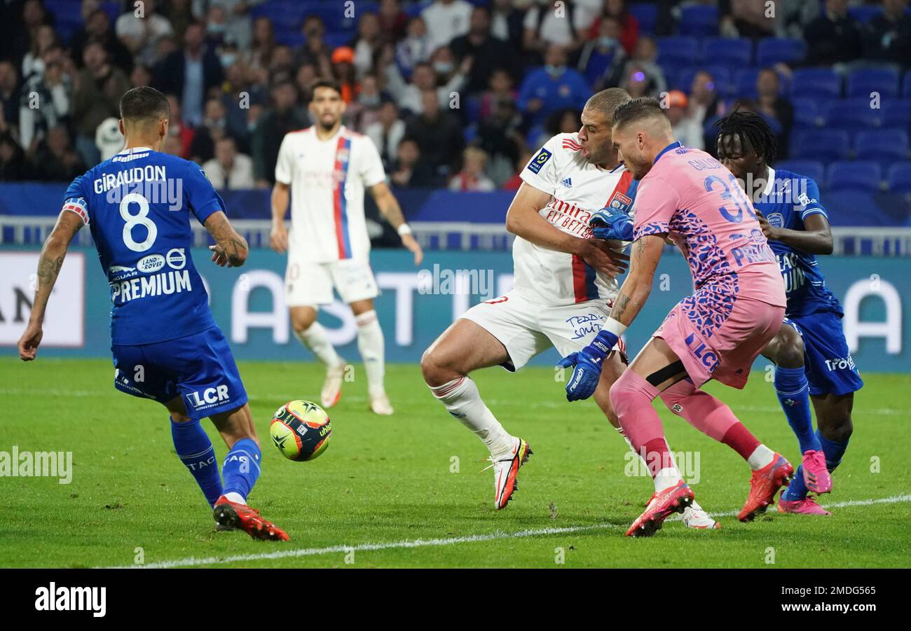 Troyes' Jimmy Giraudon, left, and Lyon's Islam Slimani battle for the ...