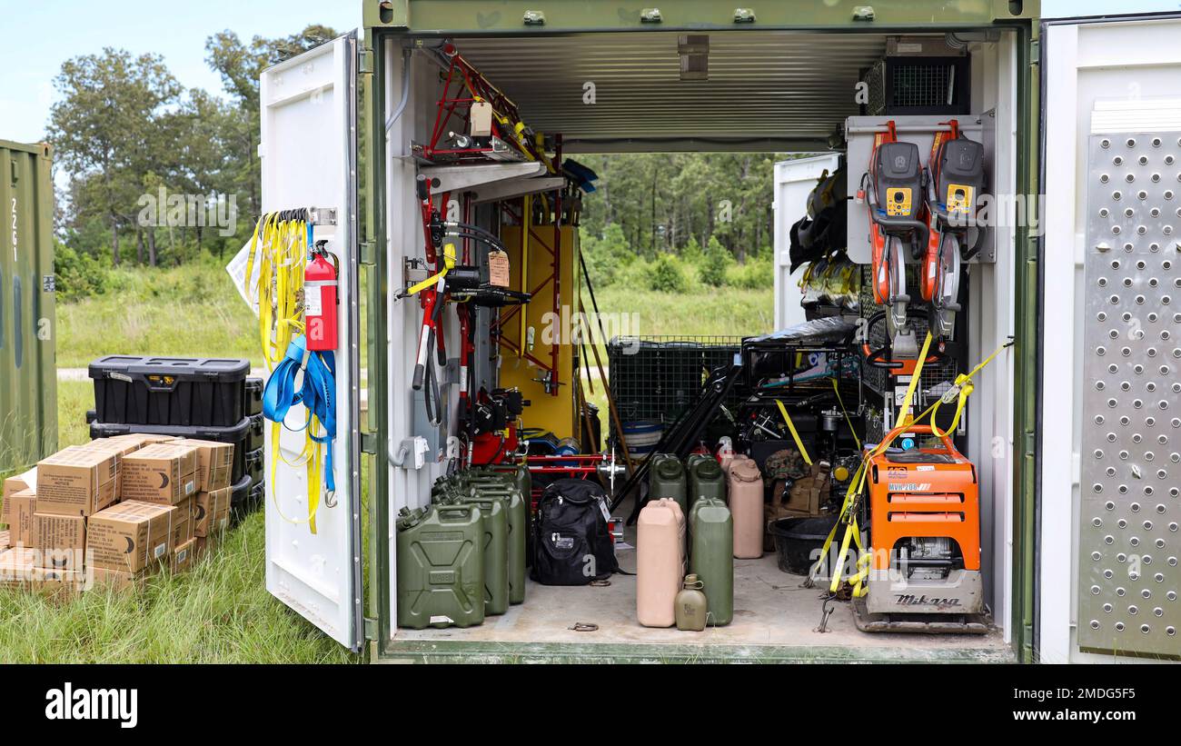 U.S. Marine Corps engineering equipment sits in a QUADCON before being ...