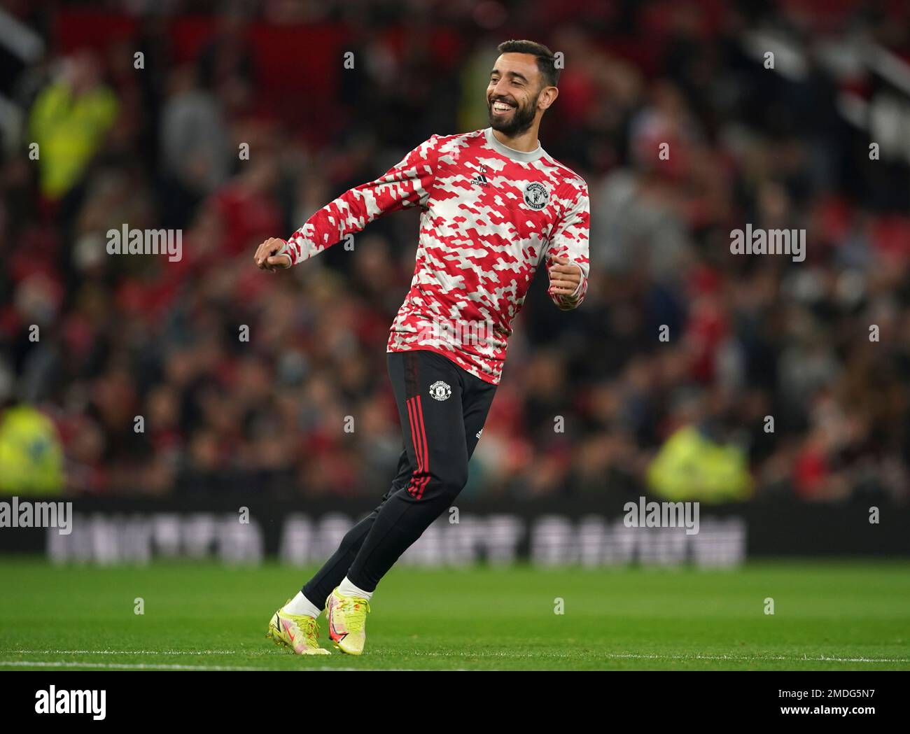 Manchester United's Bruno Fernandes smiles as he warms-up before the ...