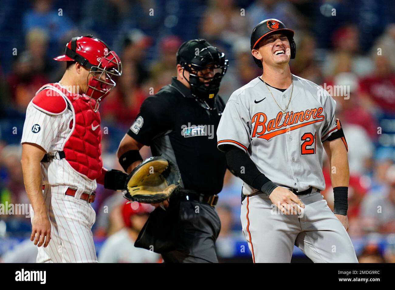 Baltimore Orioles' Austin Hays, right, reacts after being hit by a ...