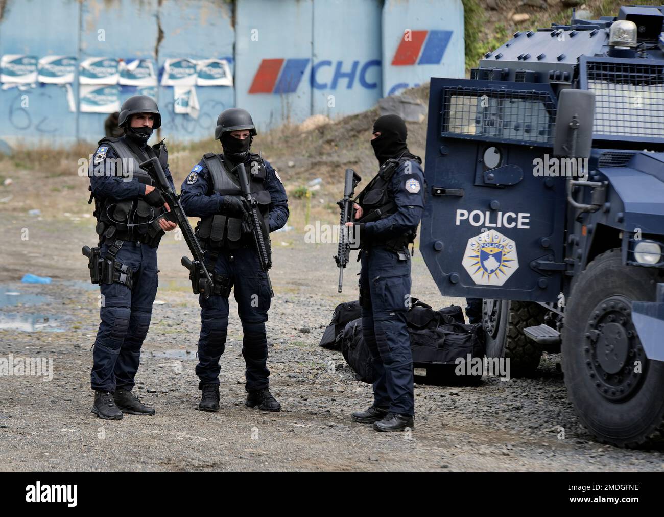 Kosovo police officers guard a road near the northern Kosovo border ...